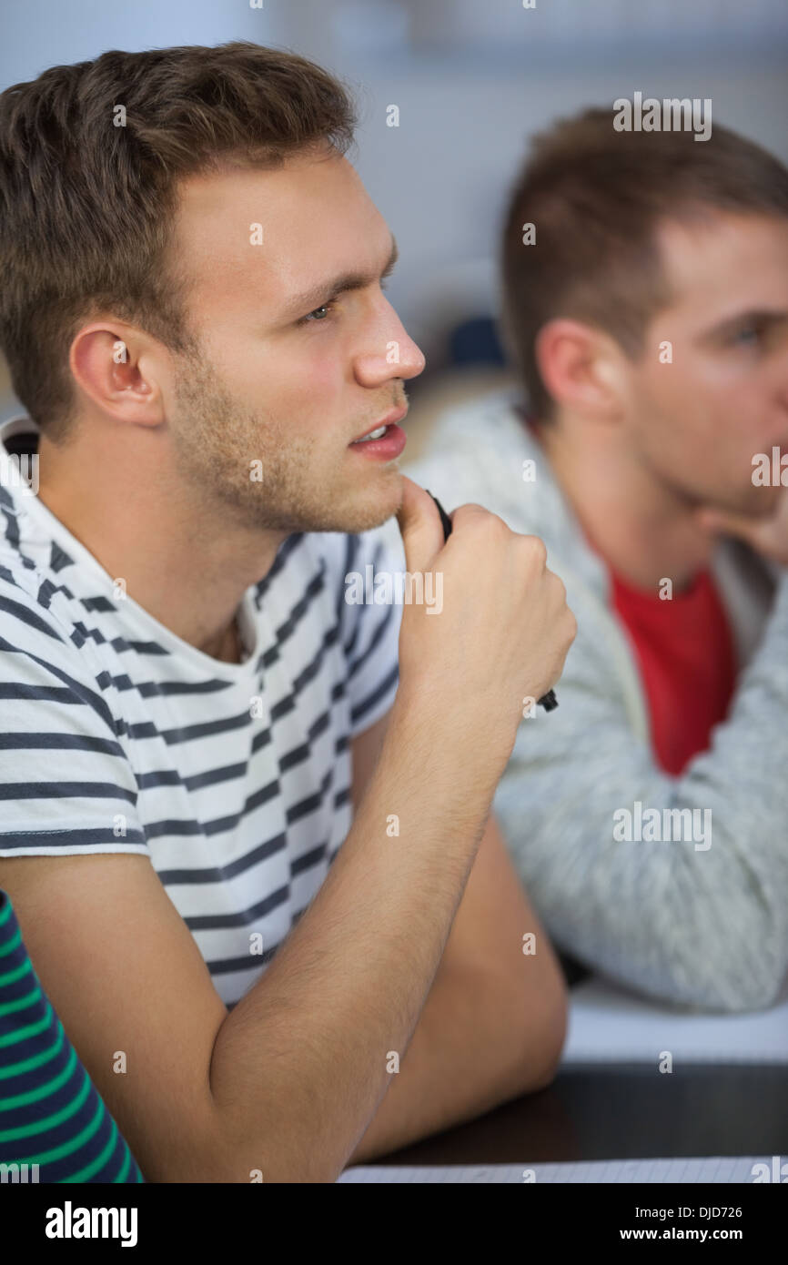 Frowning handsome student looking away Stock Photo - Alamy