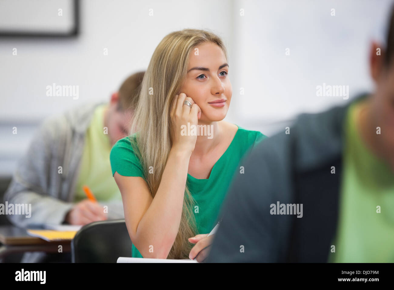 Happy blonde student listening in class Stock Photo - Alamy