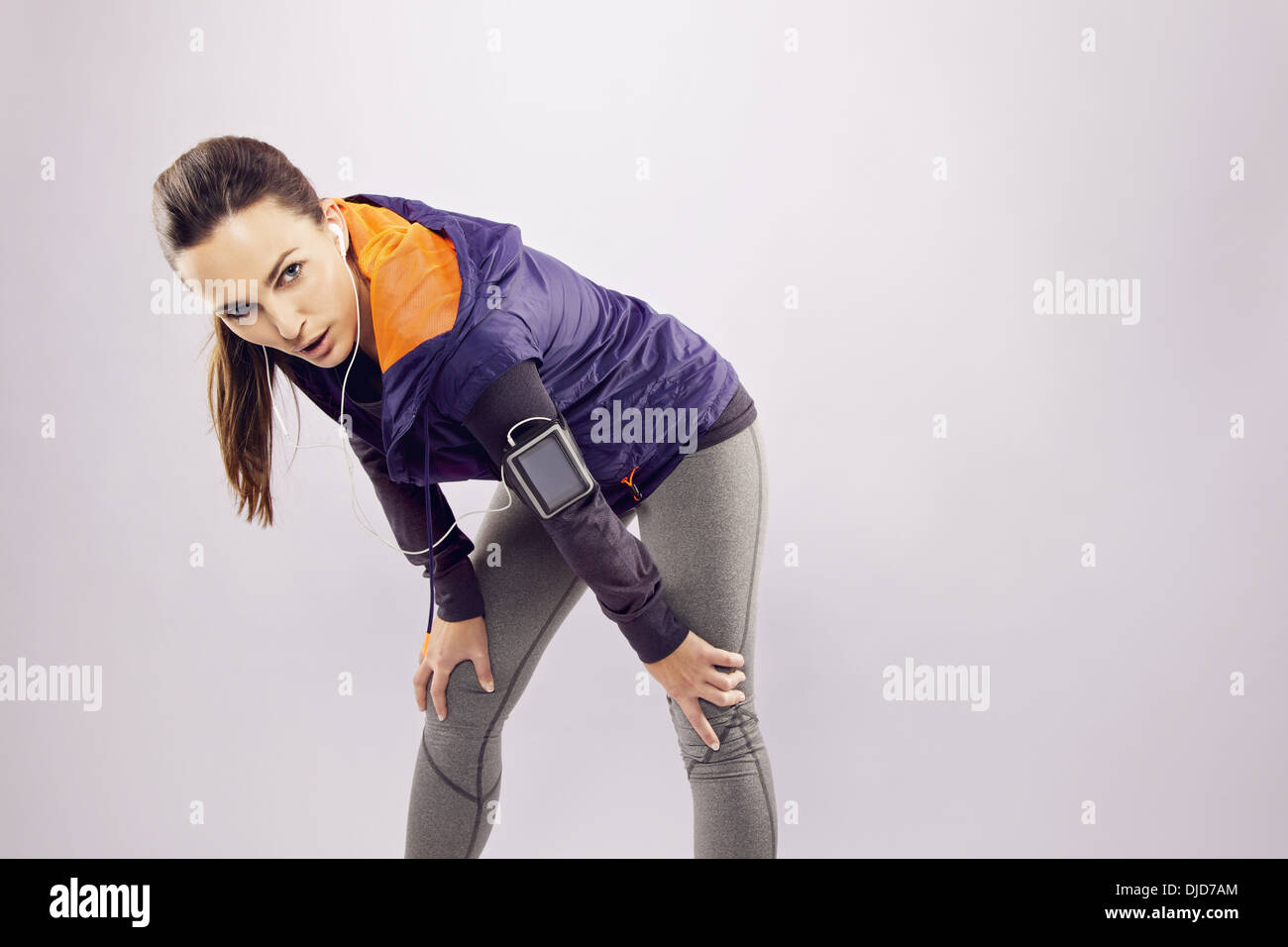 Beautiful young woman in sportswear looking tired after a run. Female ...