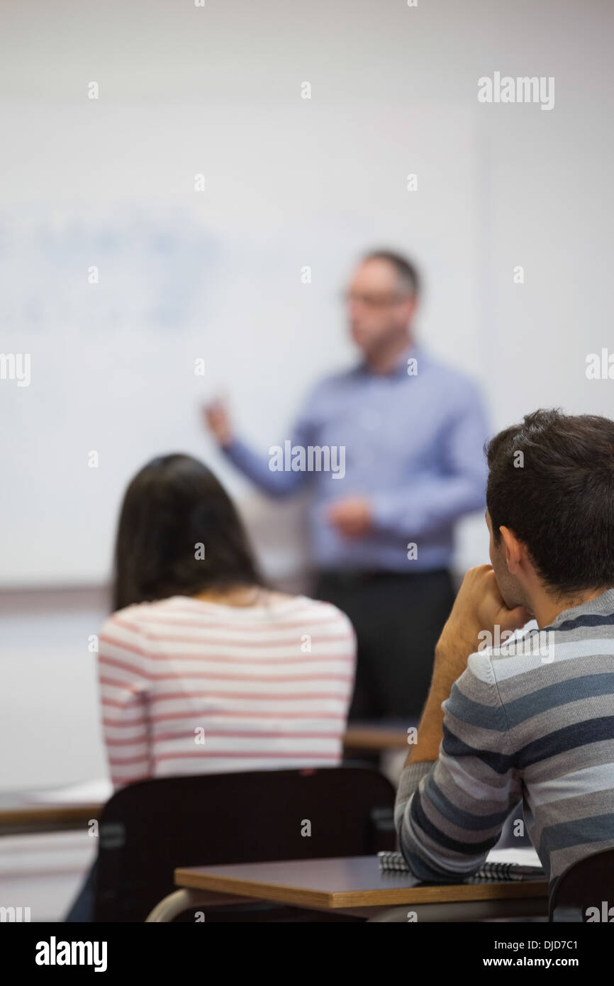 Students listening to their lecturer in classroom Stock Photo - Alamy