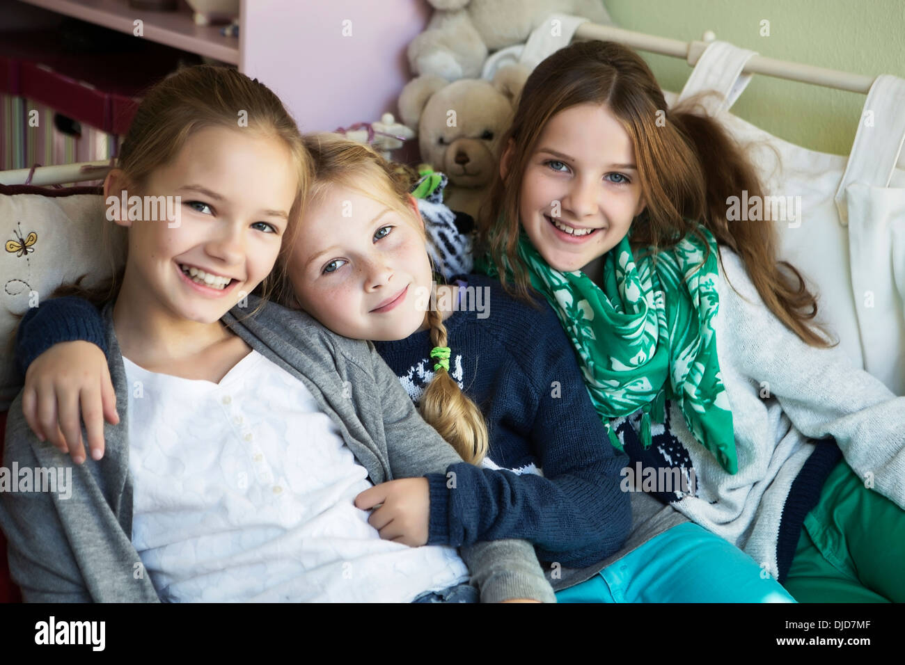 Three happy girls on bed Stock Photo - Alamy