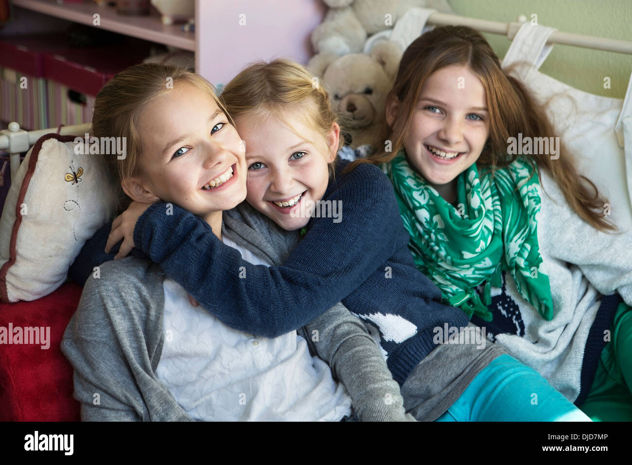 Three happy girls on bed Stock Photo - Alamy