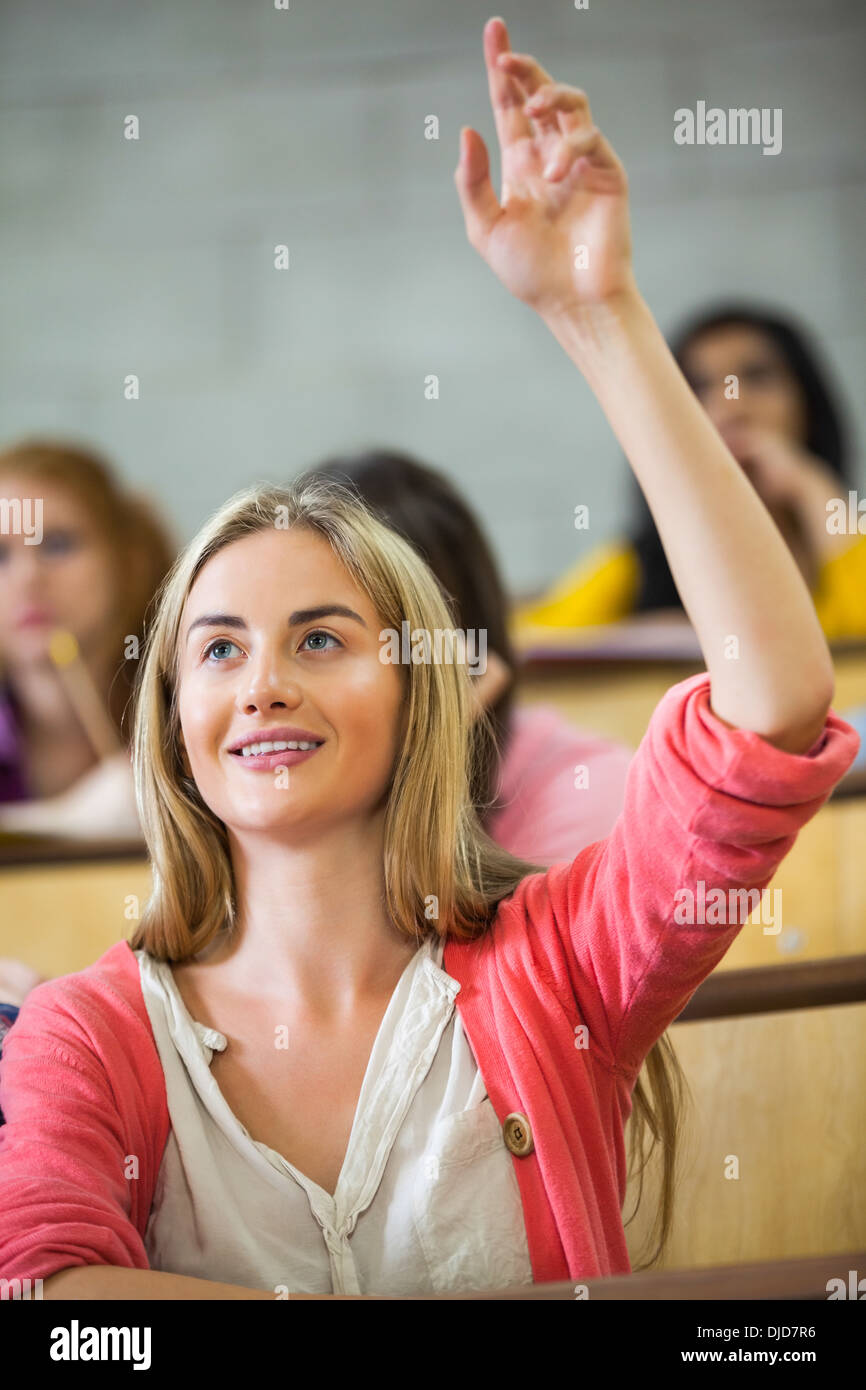 Happy student raising her hand in lecture Stock Photo - Alamy