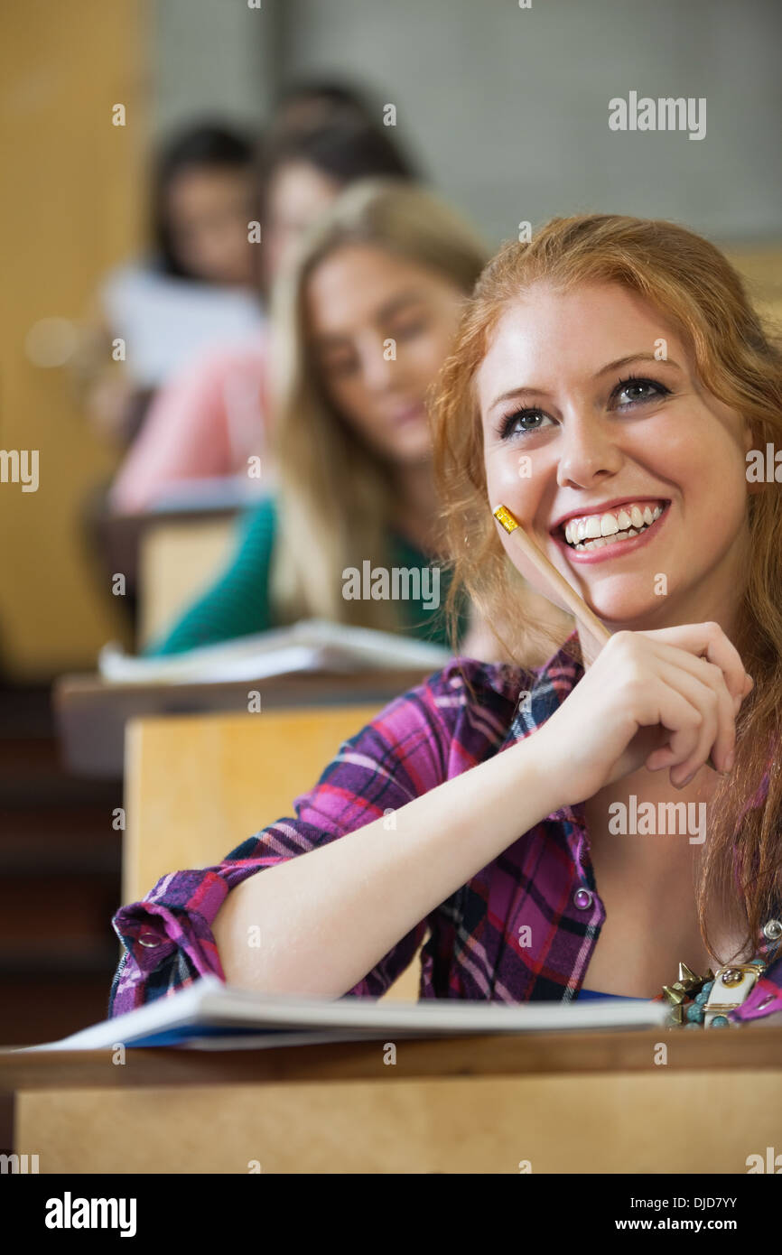 Thoughtful red head student listening in a lecture hall Stock Photo - Alamy