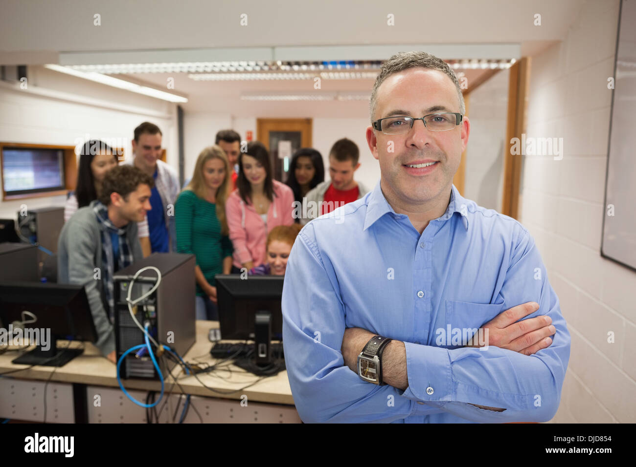 Computer teacher standing in front of his class Stock Photo - Alamy