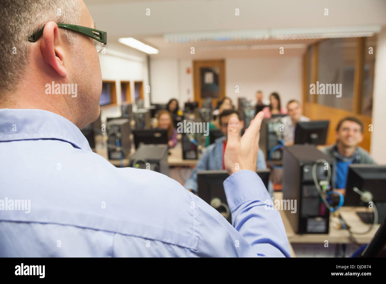 Smiling students listening to teacher in their computer class Stock ...