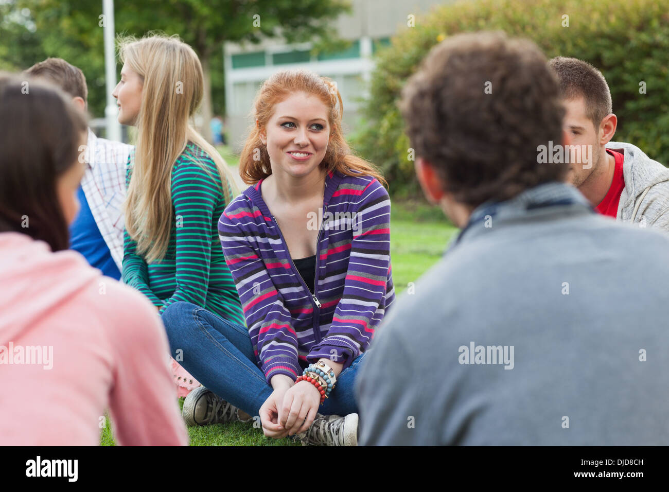 Happy students taking a break outside on campus Stock Photo - Alamy