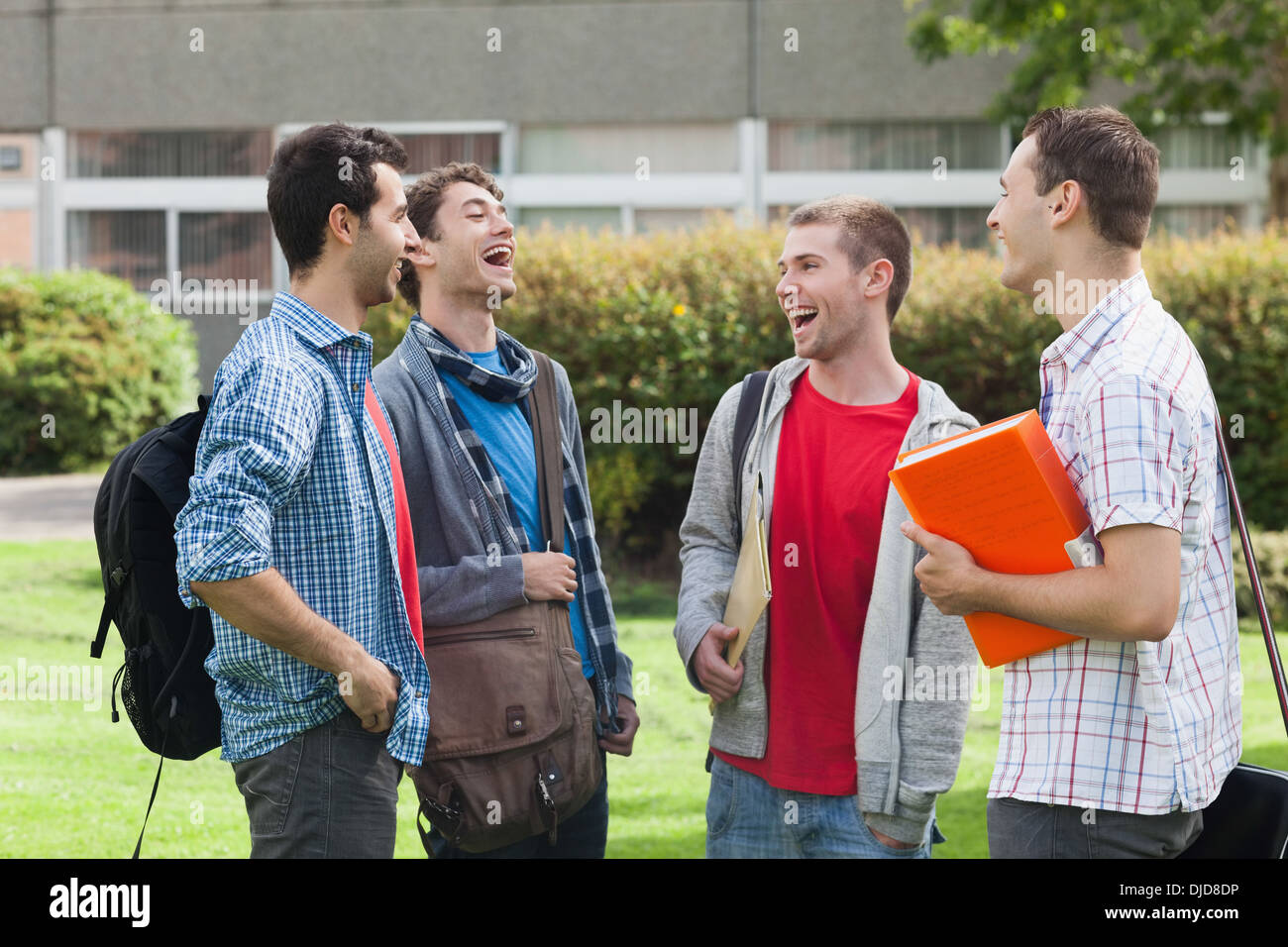 Happy young students laughing together outside on campus Stock Photo ...