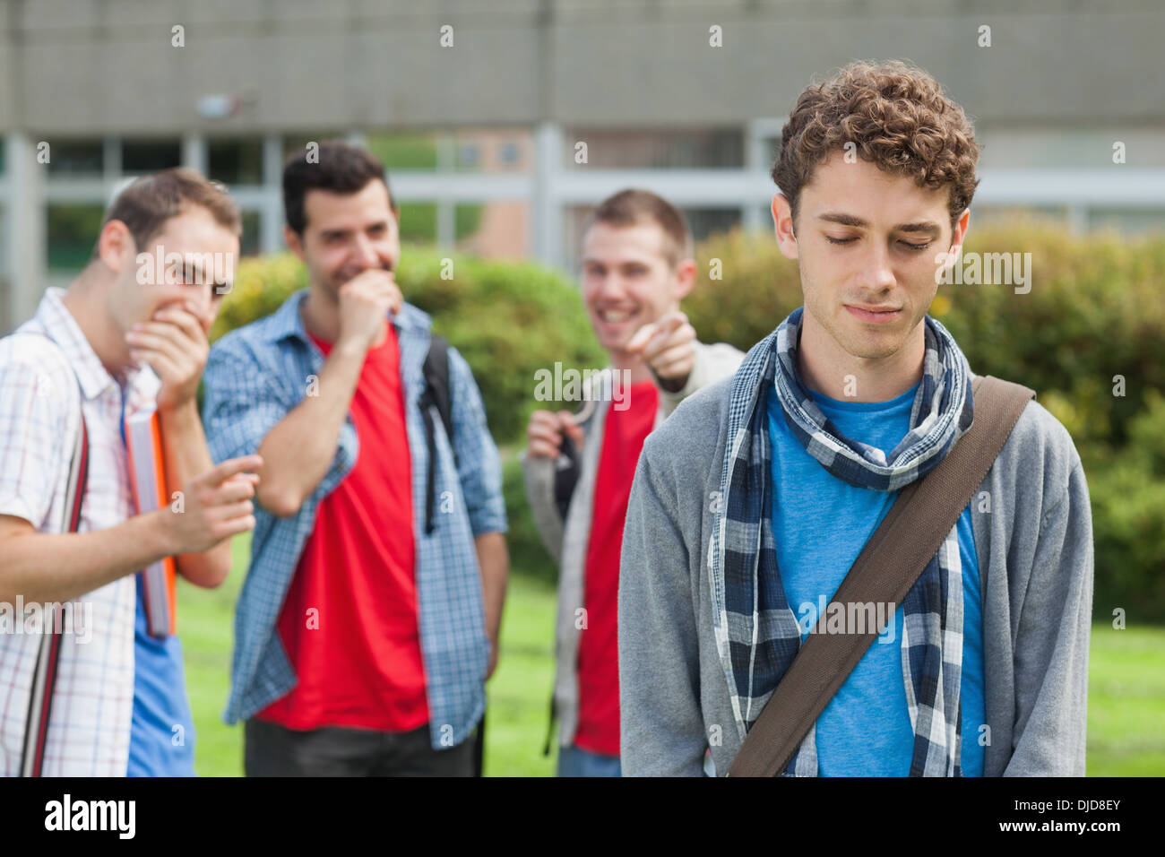 Lonely student being bullied by group of brutish classmates Stock Photo ...