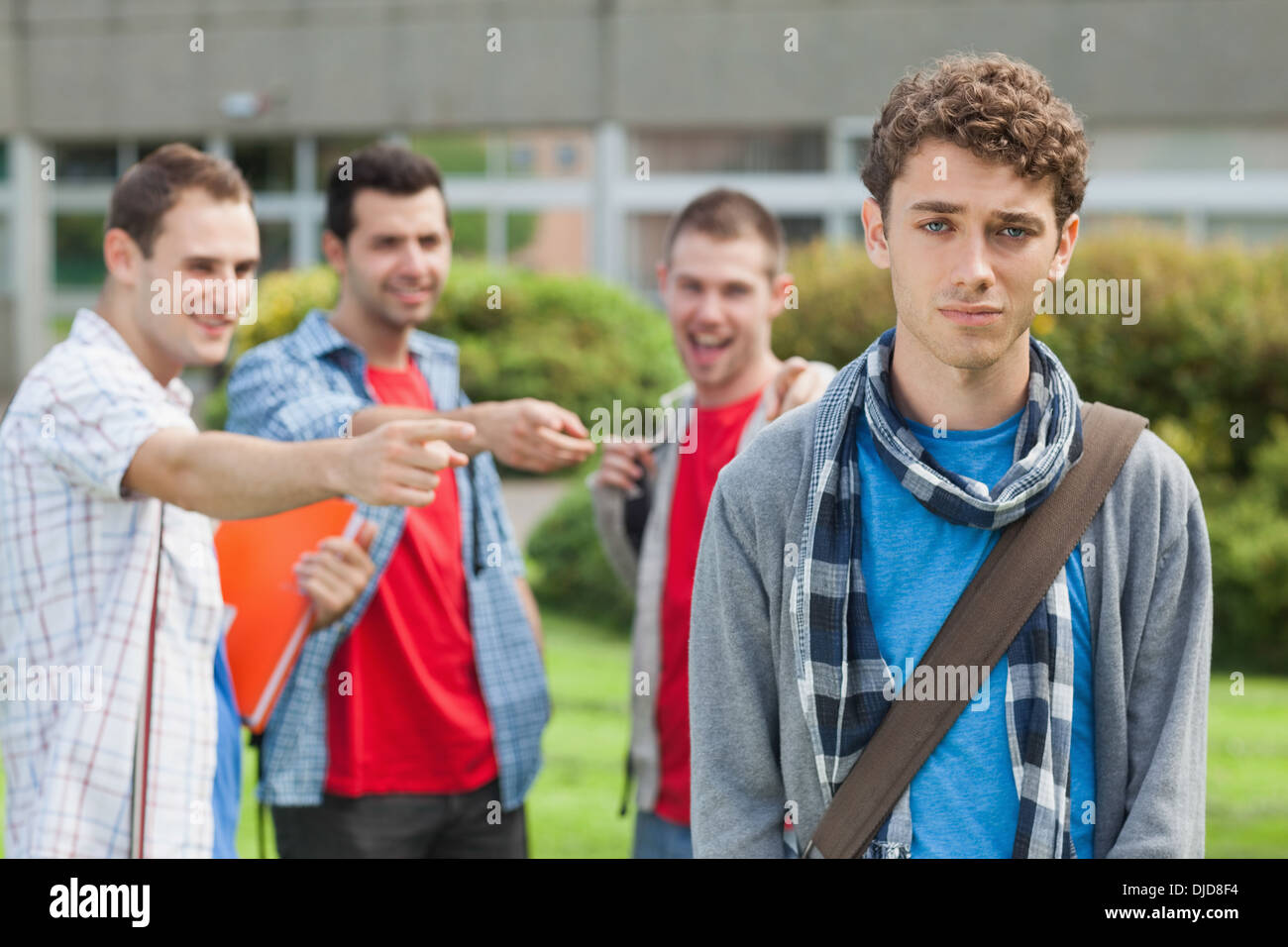 Lonely student being bullied by group of brutish classmates looking ...