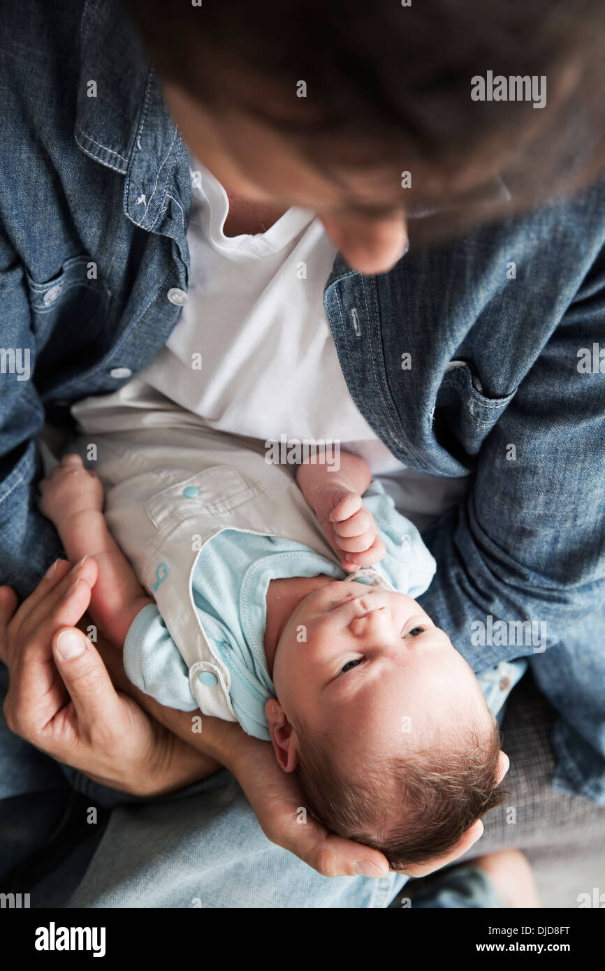 Young father holding his newborn son Stock Photo - Alamy