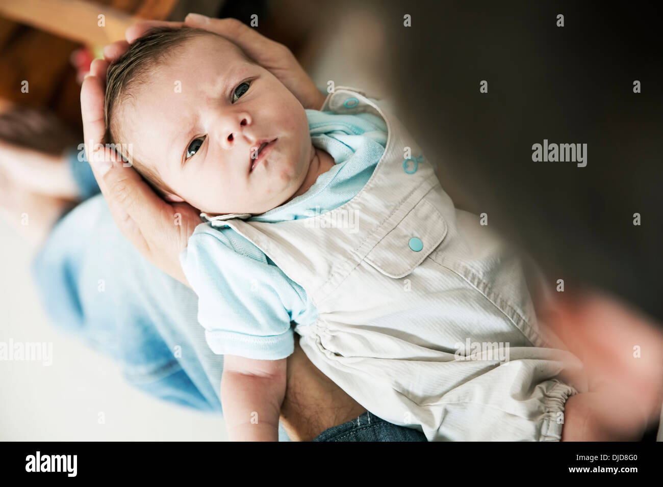 Young father holding his newborn son Stock Photo - Alamy
