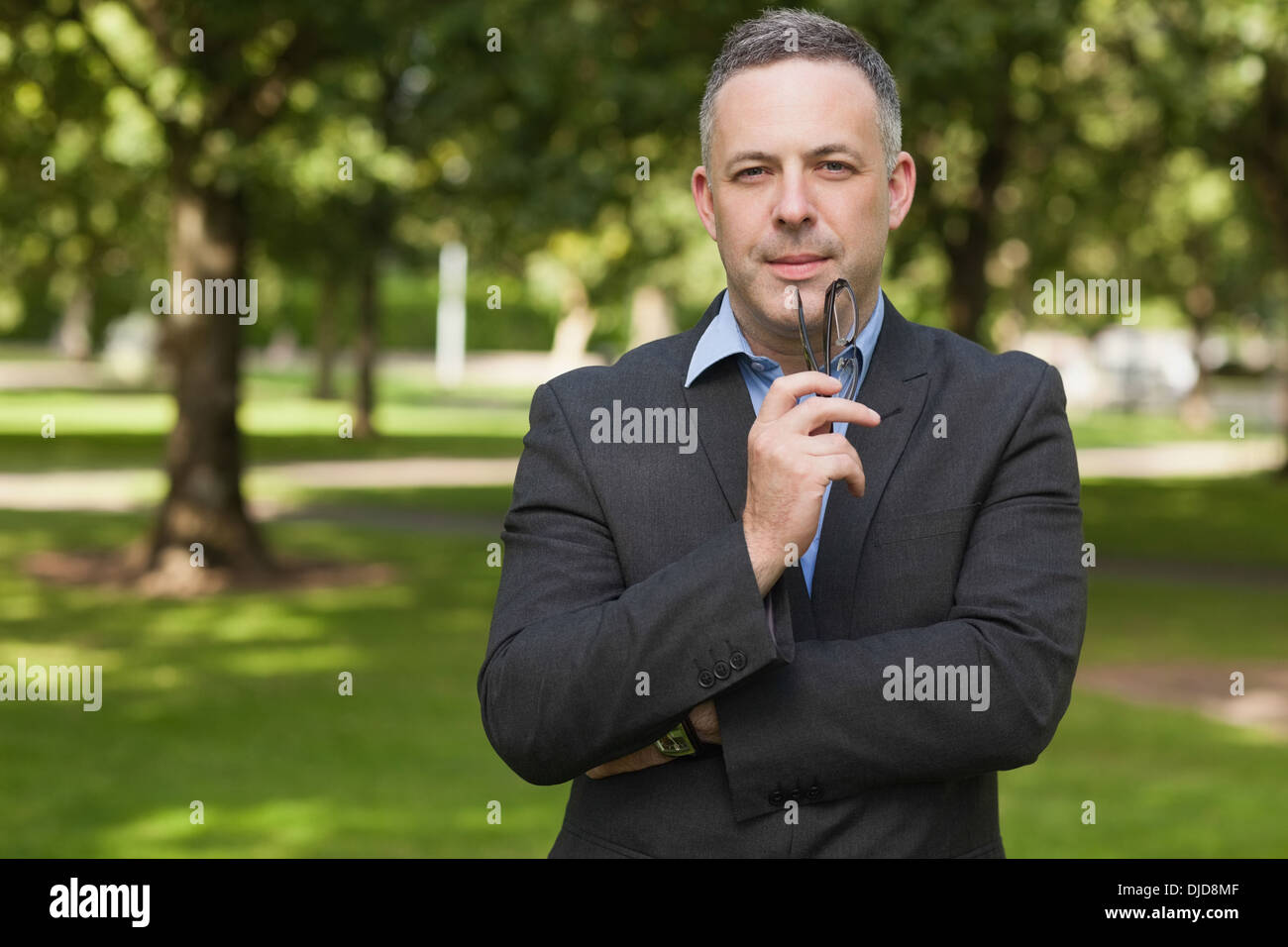 Thoughtful professor looking at camera on campus Stock Photo - Alamy