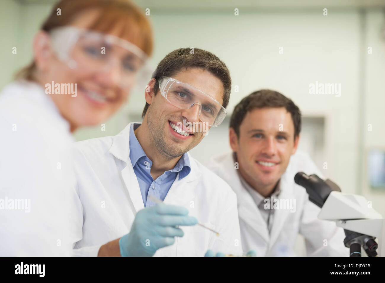 Three young scientists being in a laboratory Stock Photo - Alamy