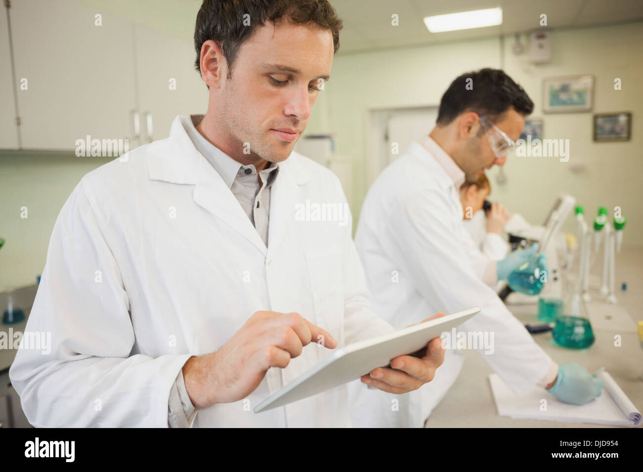 Young male scientist working with his tablet Stock Photo - Alamy