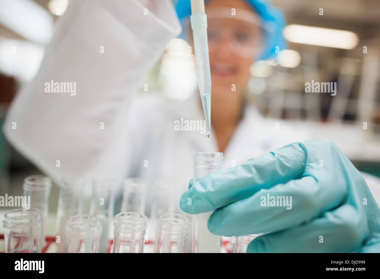 Student using pipette holding test tube Stock Photo - Alamy