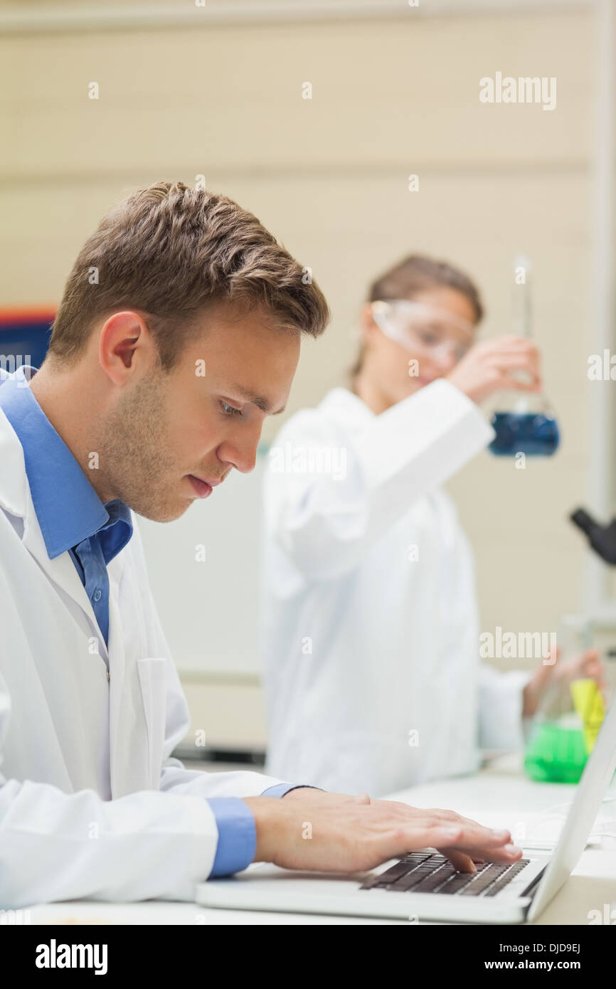 Male student holding laptop hi-res stock photography and images - Alamy