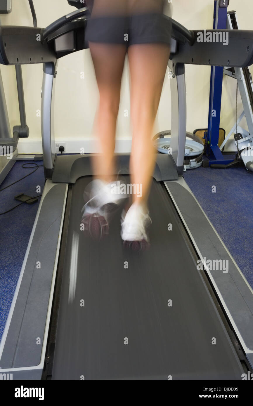 Woman running on treadmill Stock Photo - Alamy