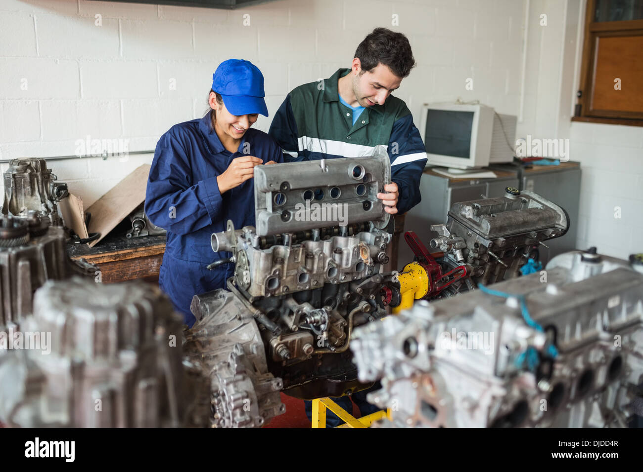 Smiling trainee and instructor checking engine Stock Photo - Alamy