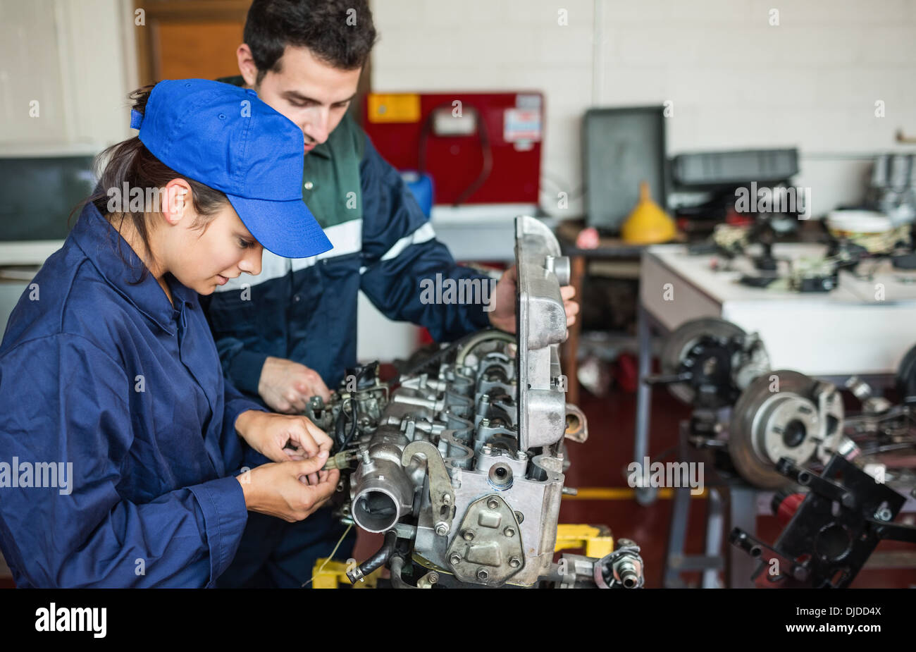 Focused trainee and instructor checking engine Stock Photo - Alamy