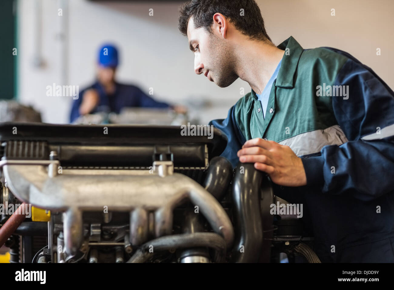 Instructor checking a machine Stock Photo - Alamy