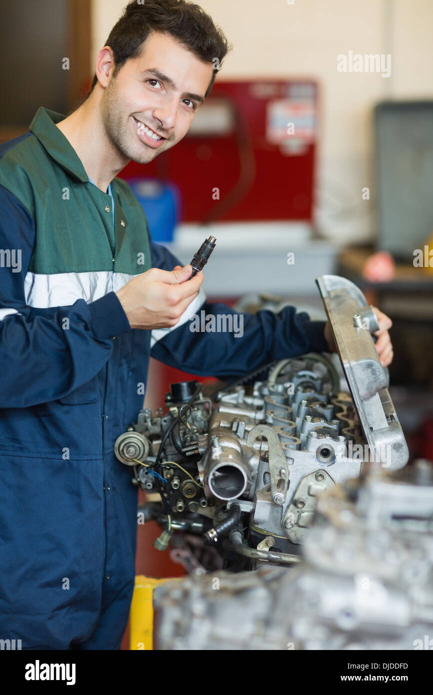 Happy repairman repairing an engine Stock Photo - Alamy