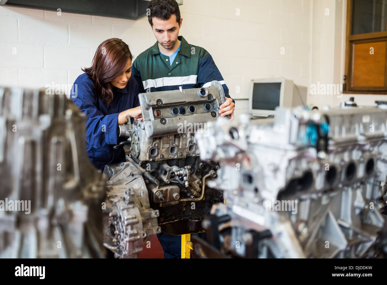 Trainee and instructor repairing an engine Stock Photo - Alamy