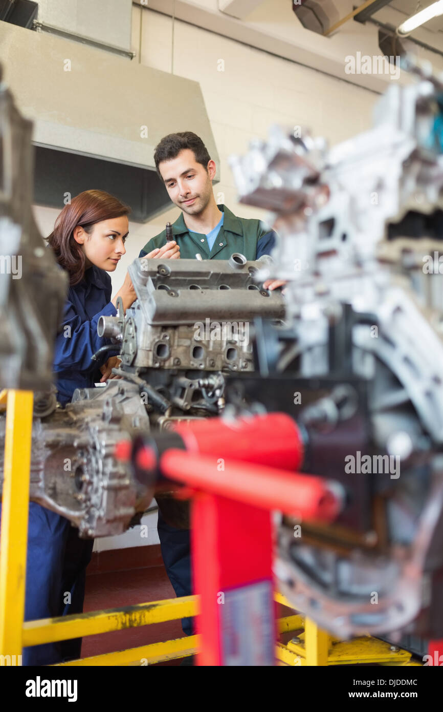Concentrating trainee and instructor repairing an engine Stock Photo ...