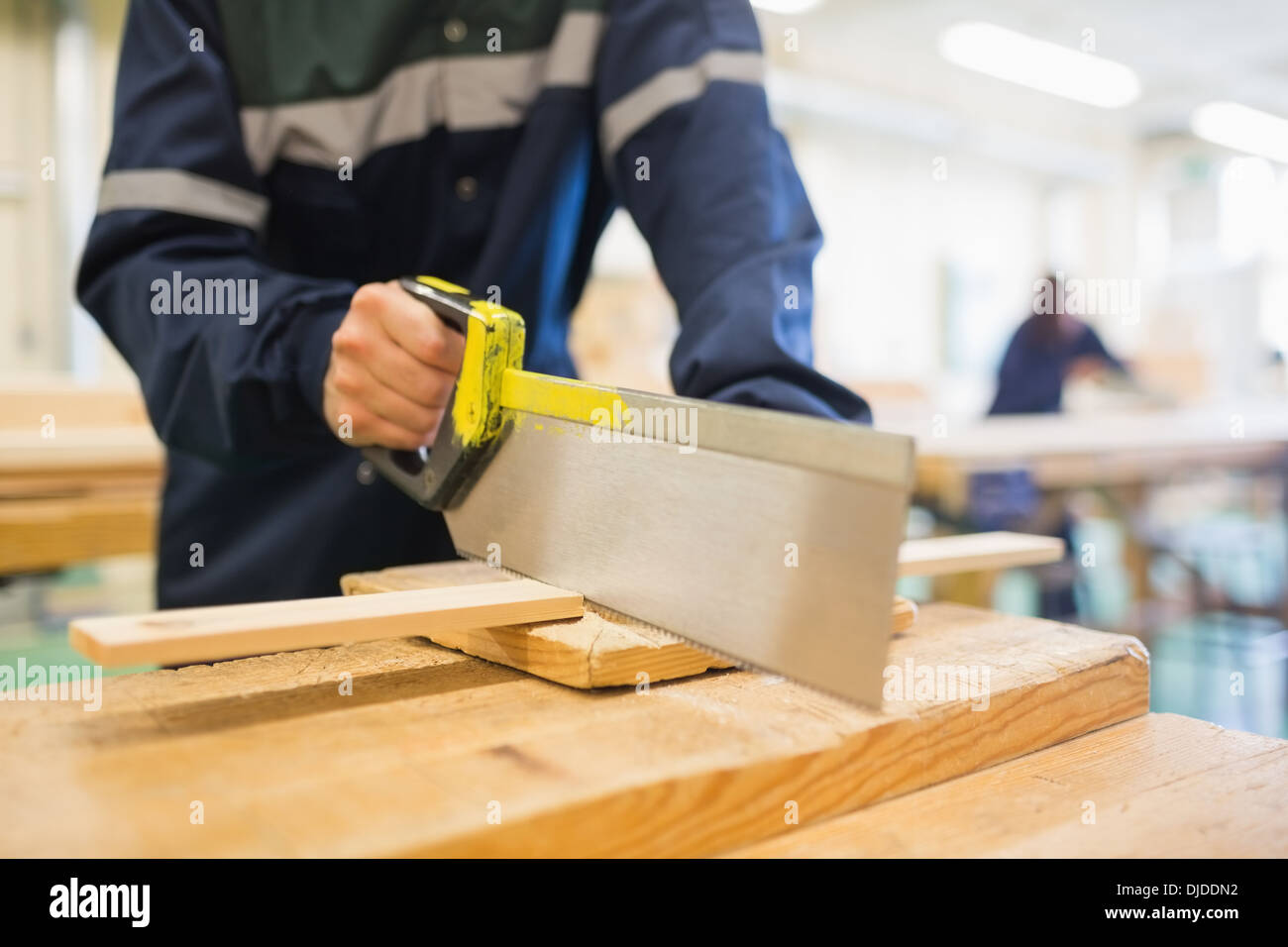 Carpenter sawing wood Stock Photo - Alamy