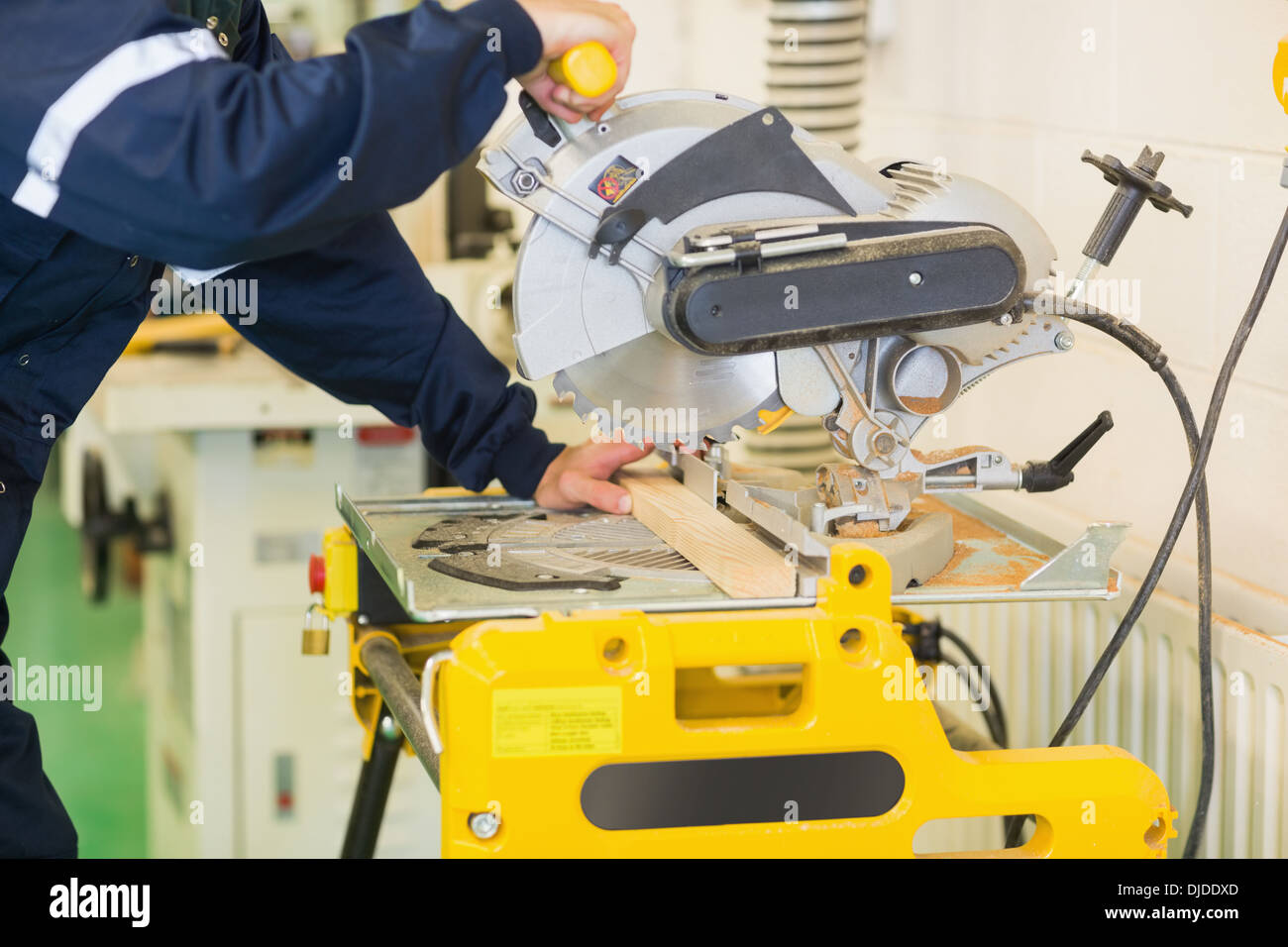 Craftsman sawing a piece of wood Stock Photo - Alamy