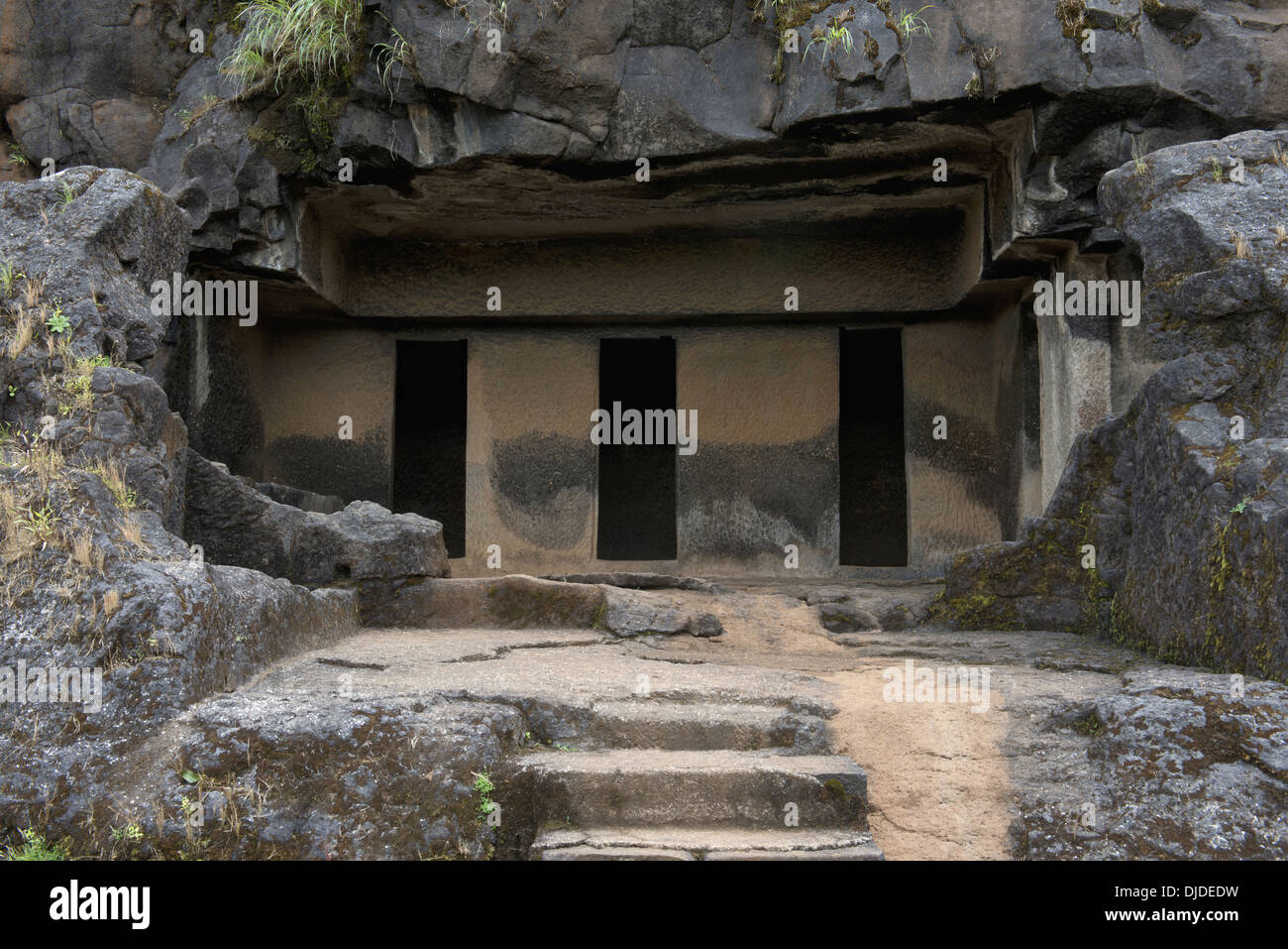 Facade of a vihara showing three cell doors with rock-cut benches ...