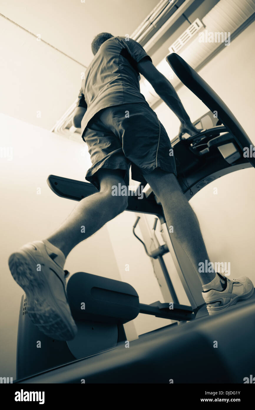 Low angle view of a healthy man running on treadmill Stock Photo - Alamy