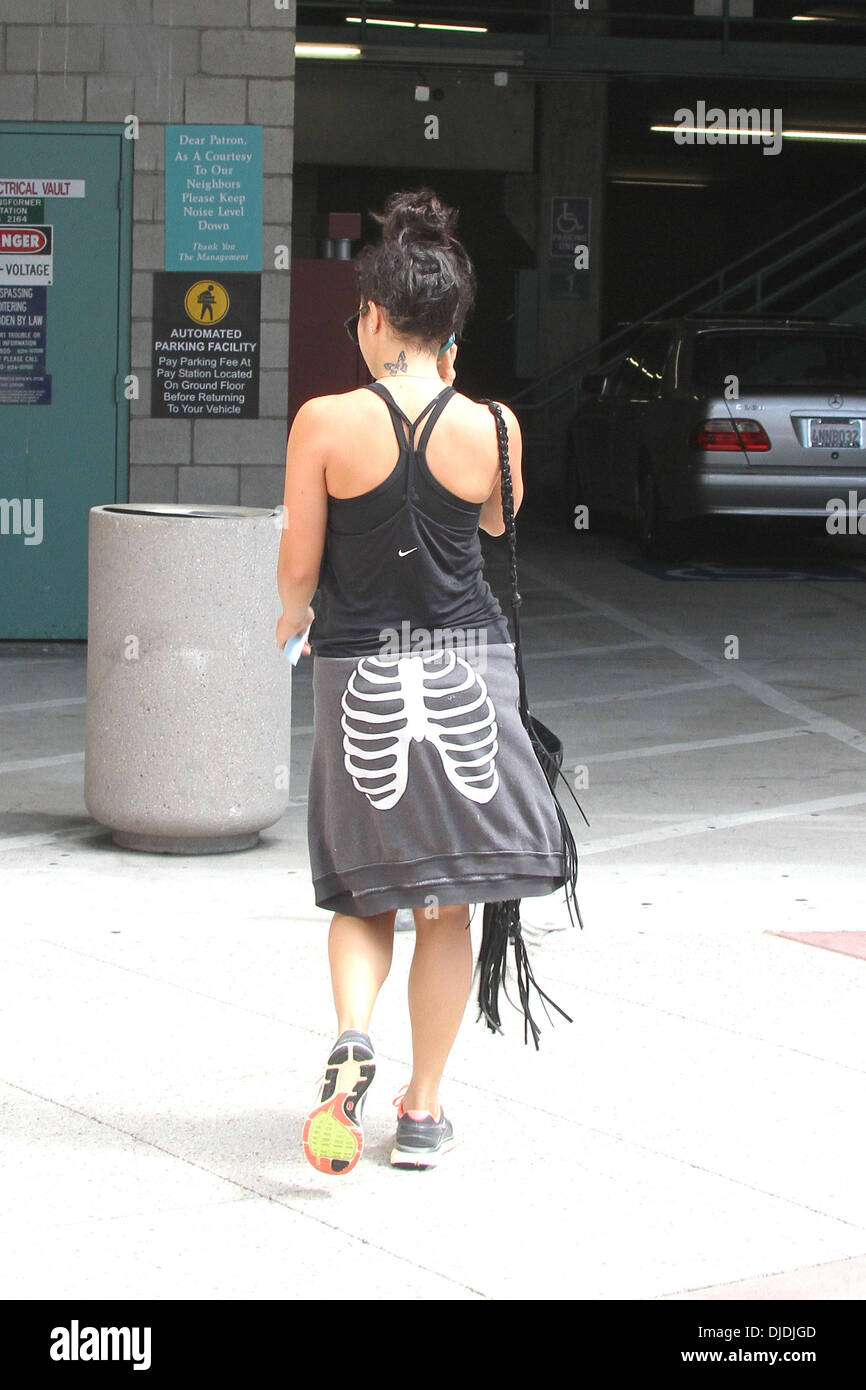 Vanessa Hudgens on her cell phone as she leaves her gym after a workout ...