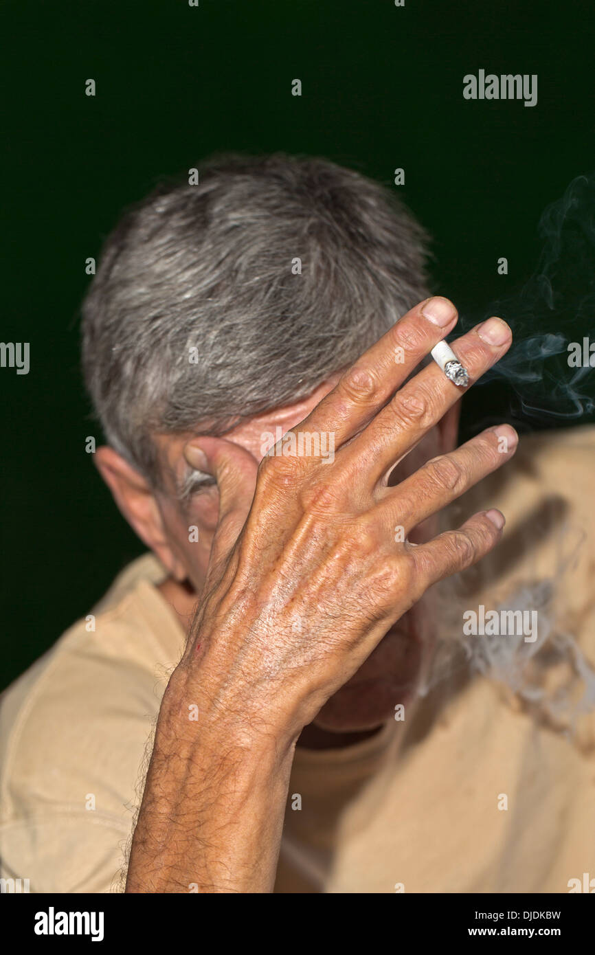 Elderly man smoking a cigarette Stock Photo - Alamy