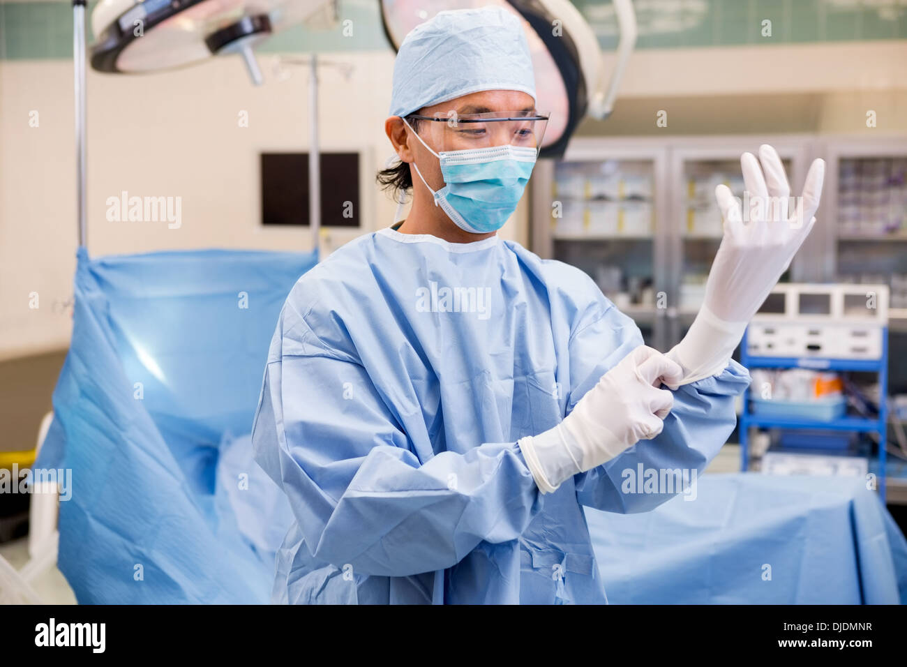 Surgeon Wearing Surgical Gloves In Operation Room Stock Photo - Alamy