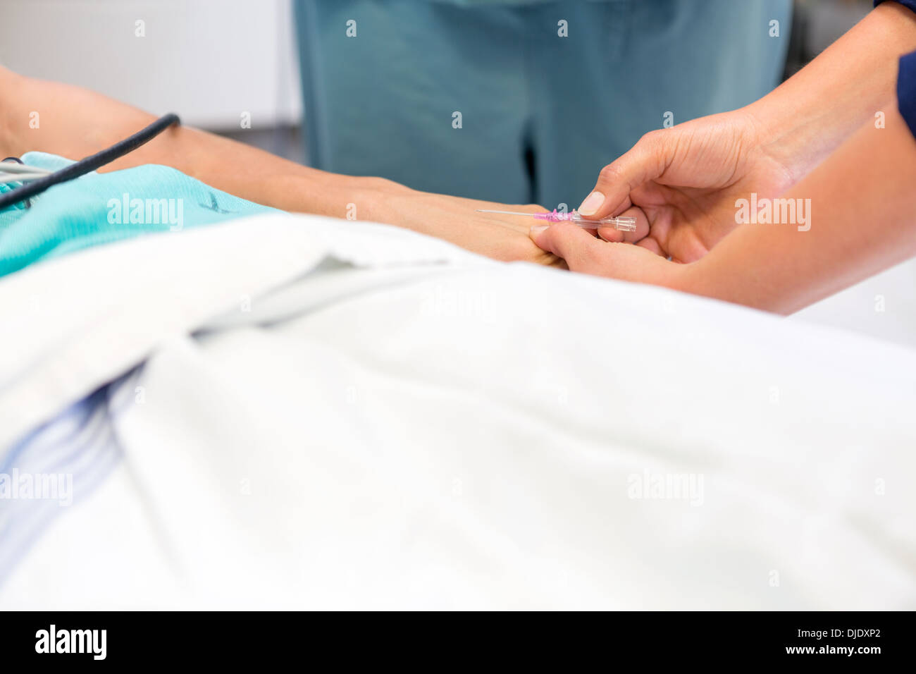Nurse Inserting Needle In Patient's Nerve At Hospital Stock Photo - Alamy