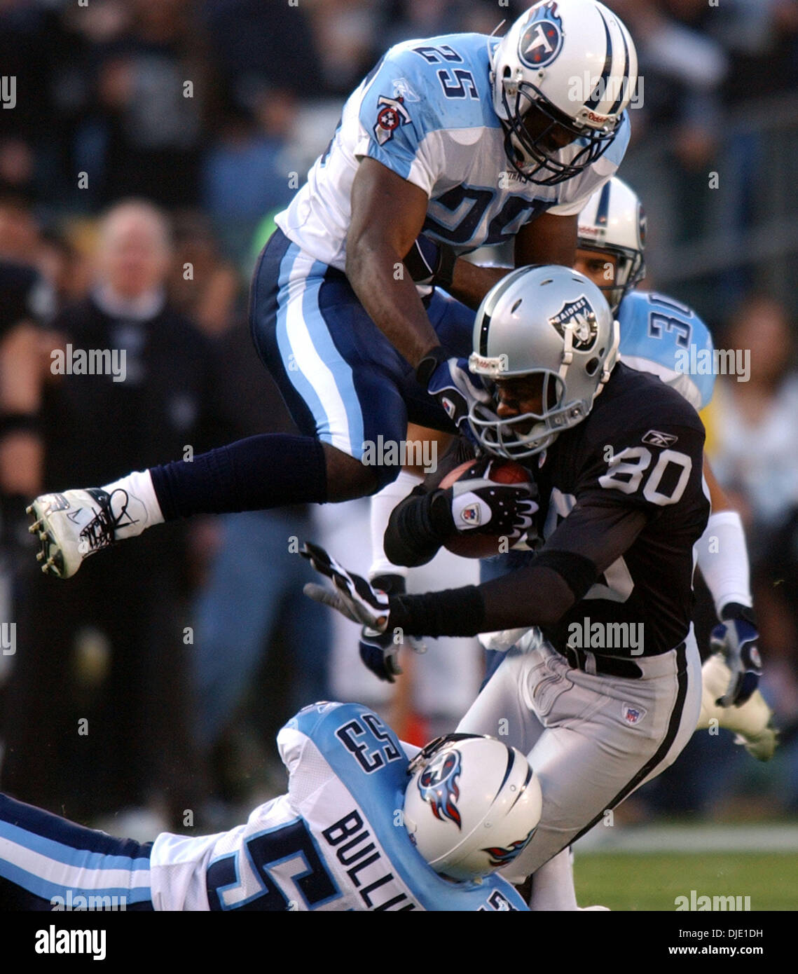 Jan 19, 2003; Oakland, CA, USA; Raider Jerry Rice is tackeled by Titans ...