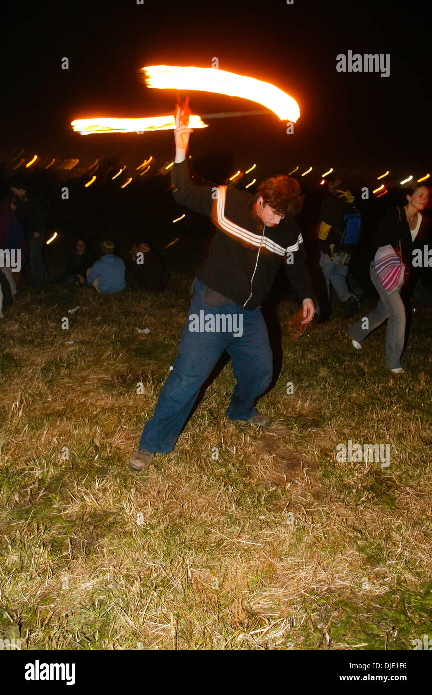 Fire Poi dancer at the stone circle Glastonbury music festival Pilton ...