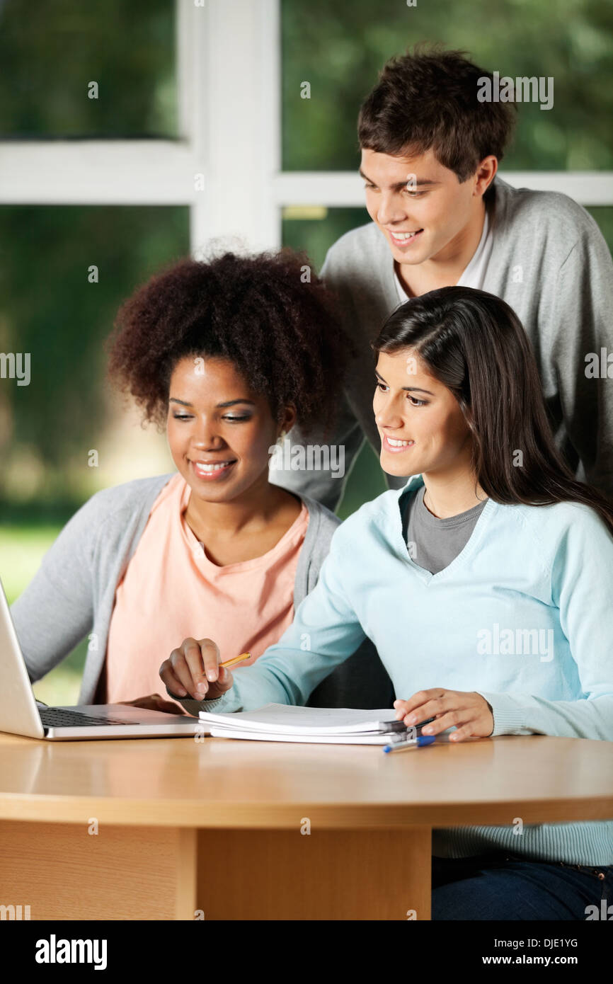 Students With Laptop Studying At Desk In Classroom Stock Photo - Alamy