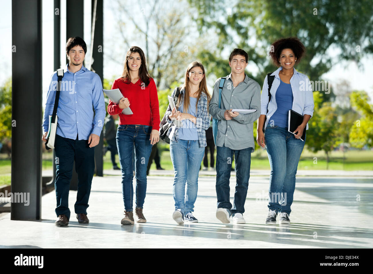 Confident Students Walking In A Row On Campus Stock Photo - Alamy