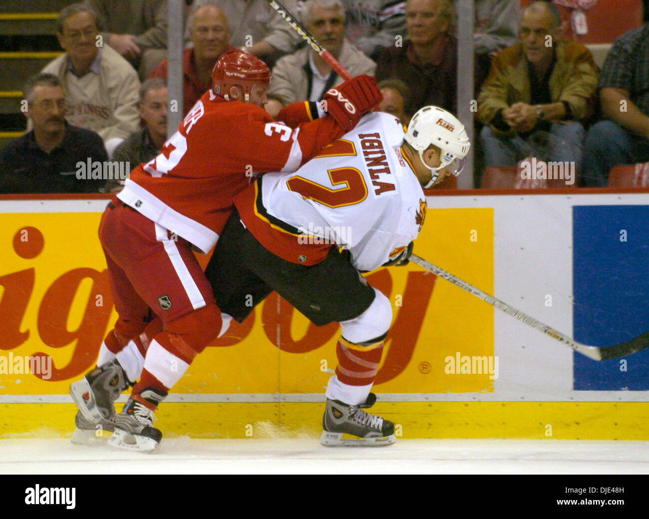 Apr 22, 2004; Detroit, MI, USA; KRIS DRAPER pounds on Calgary's JAROME ...