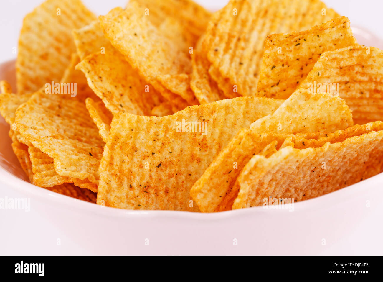 Potato chips in bowl, closeup image Stock Photo - Alamy