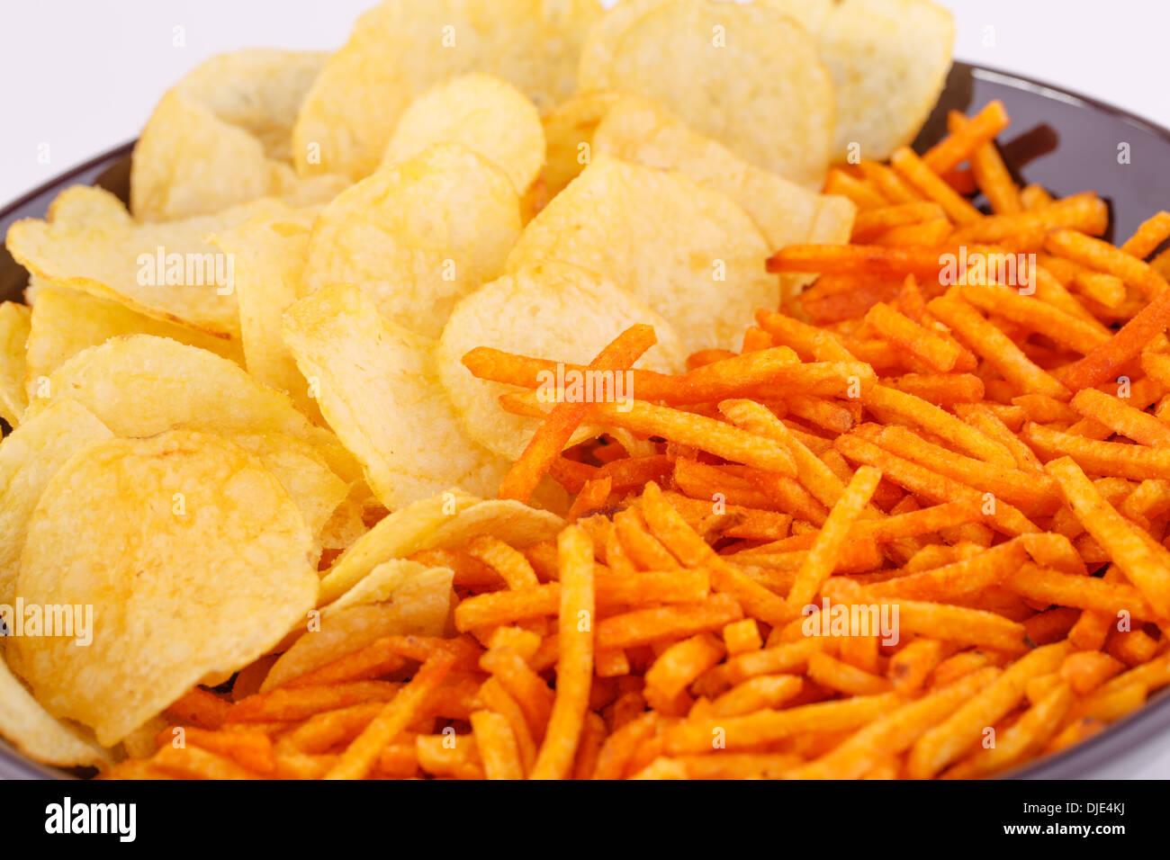 Potato chips in bowl, closeup image Stock Photo - Alamy