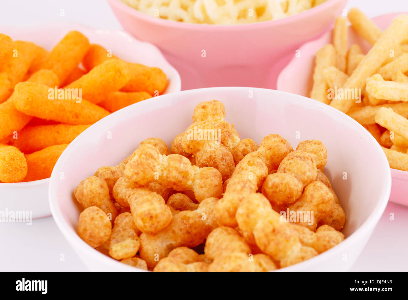 Potato, corn and wheat chips in bowls isolated on gray background Stock ...