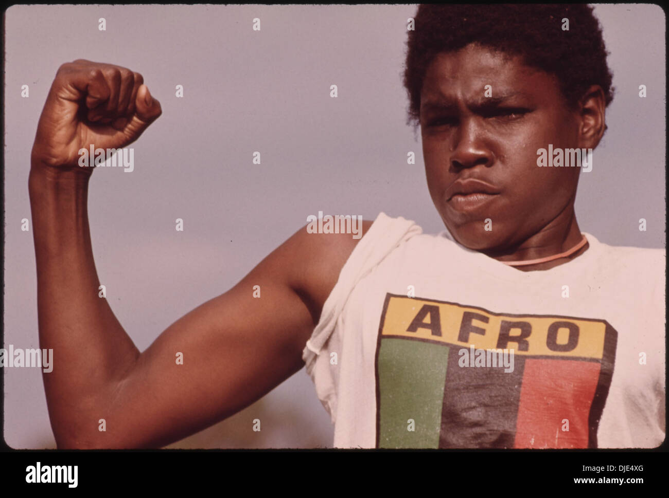 A YOUNG BLACK MAN SHOWING HIS MUSCLE DURING A SMALL COMMUNITY PROGRAM ...