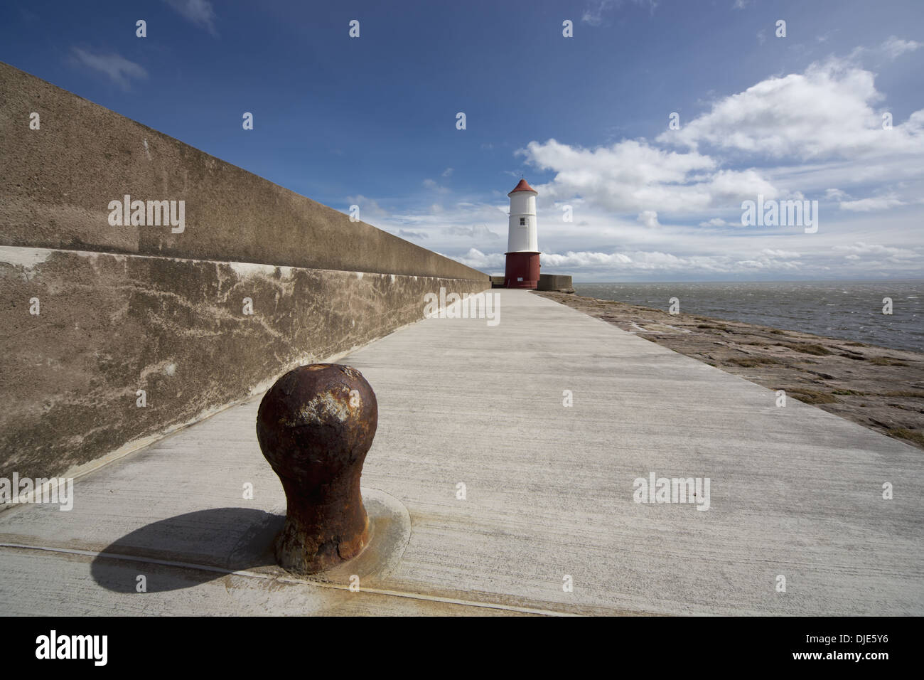 A Concrete Pier Leading To A Lighthouse; Berwick-Upon-Tweed ...