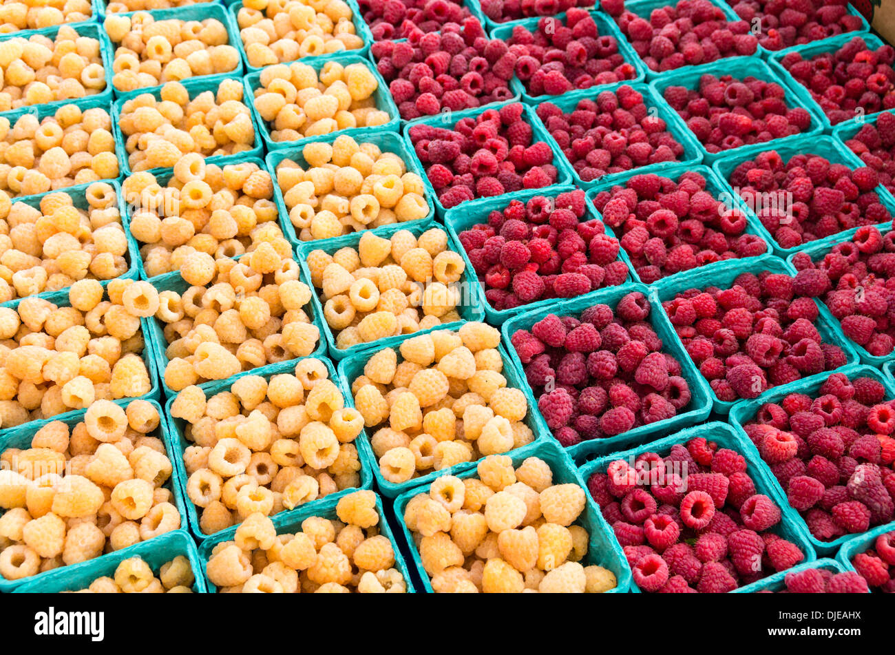 Raspberries red and yellow in small boxes at the market Stock Photo - Alamy