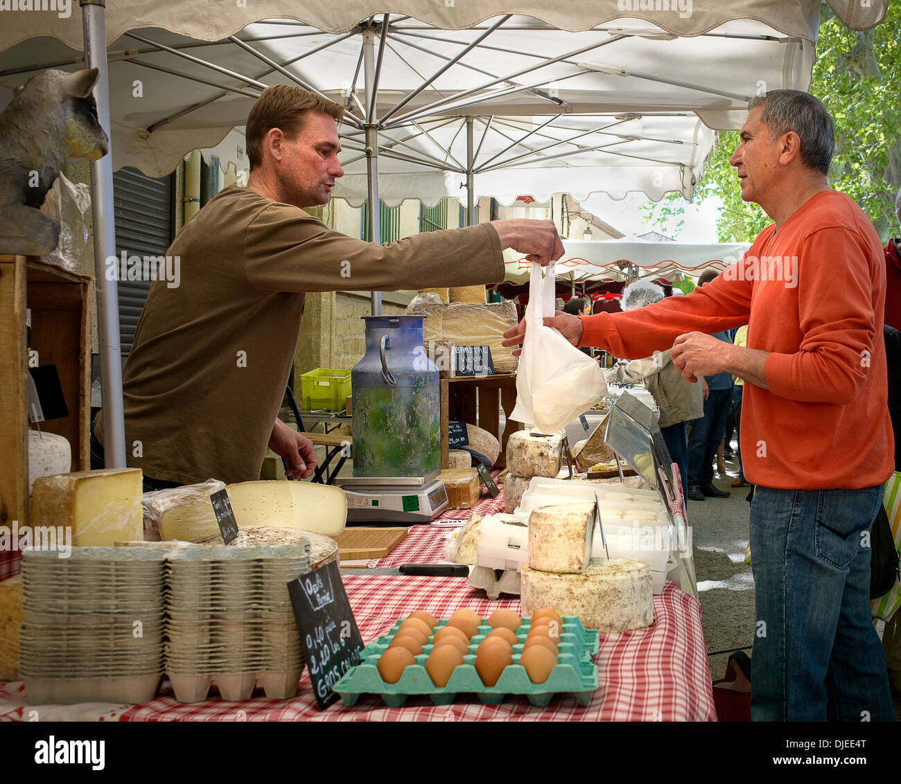 Customer buying cheese in a French open market Stock Photo - Alamy