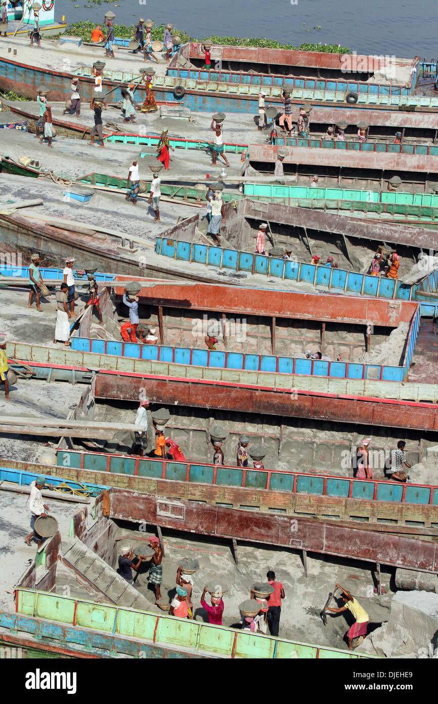 Bangladeshi laborers unload sand to the sand cargo ship at near ...