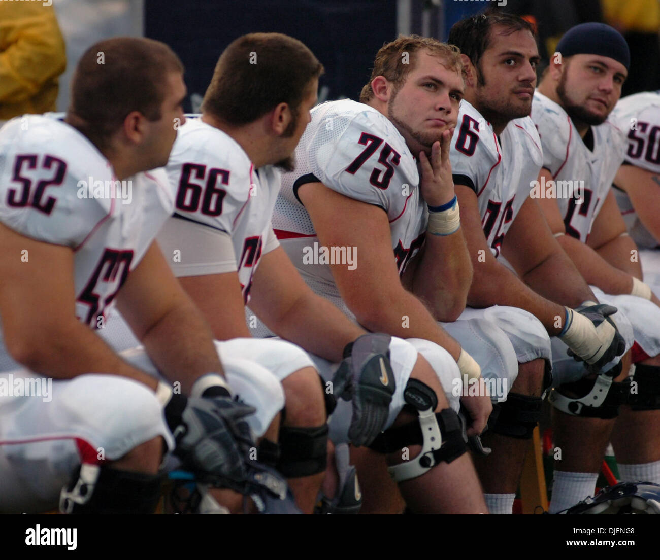 Arizona Wildcat's Joe Longacre, #75, glances up at the scoreboard as ...